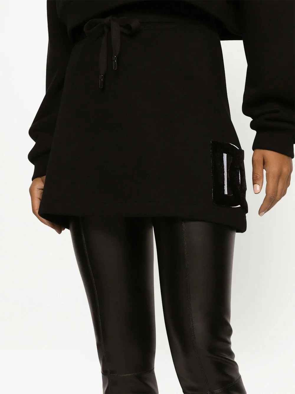 Dolce And Gabbana Logo Patch Jersey Miniskirt In Nero Modesens