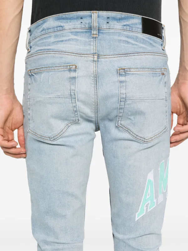 AMIRI Varsity Logo Skinny Jeans | Blue | FARFETCH AMIRI Varsity Logo Skinny Jeans | Blue | FARFETCH